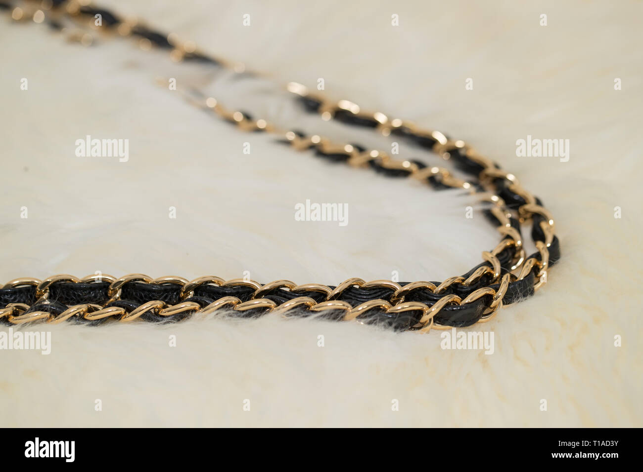 Photo of black handbag chain on the table Stock Photo - Alamy