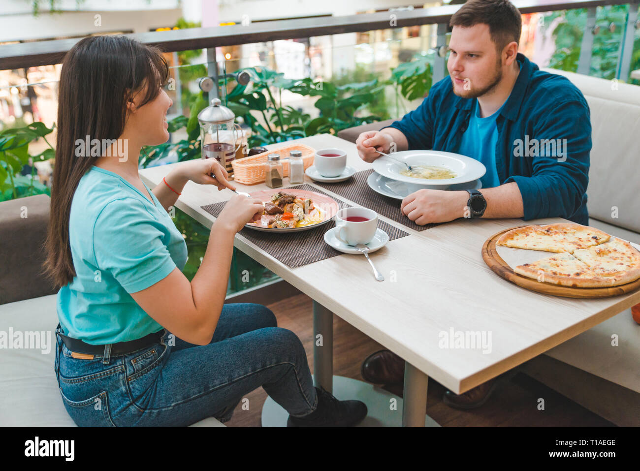 couple having lunch in mall cafe together. date talking. relationship ...