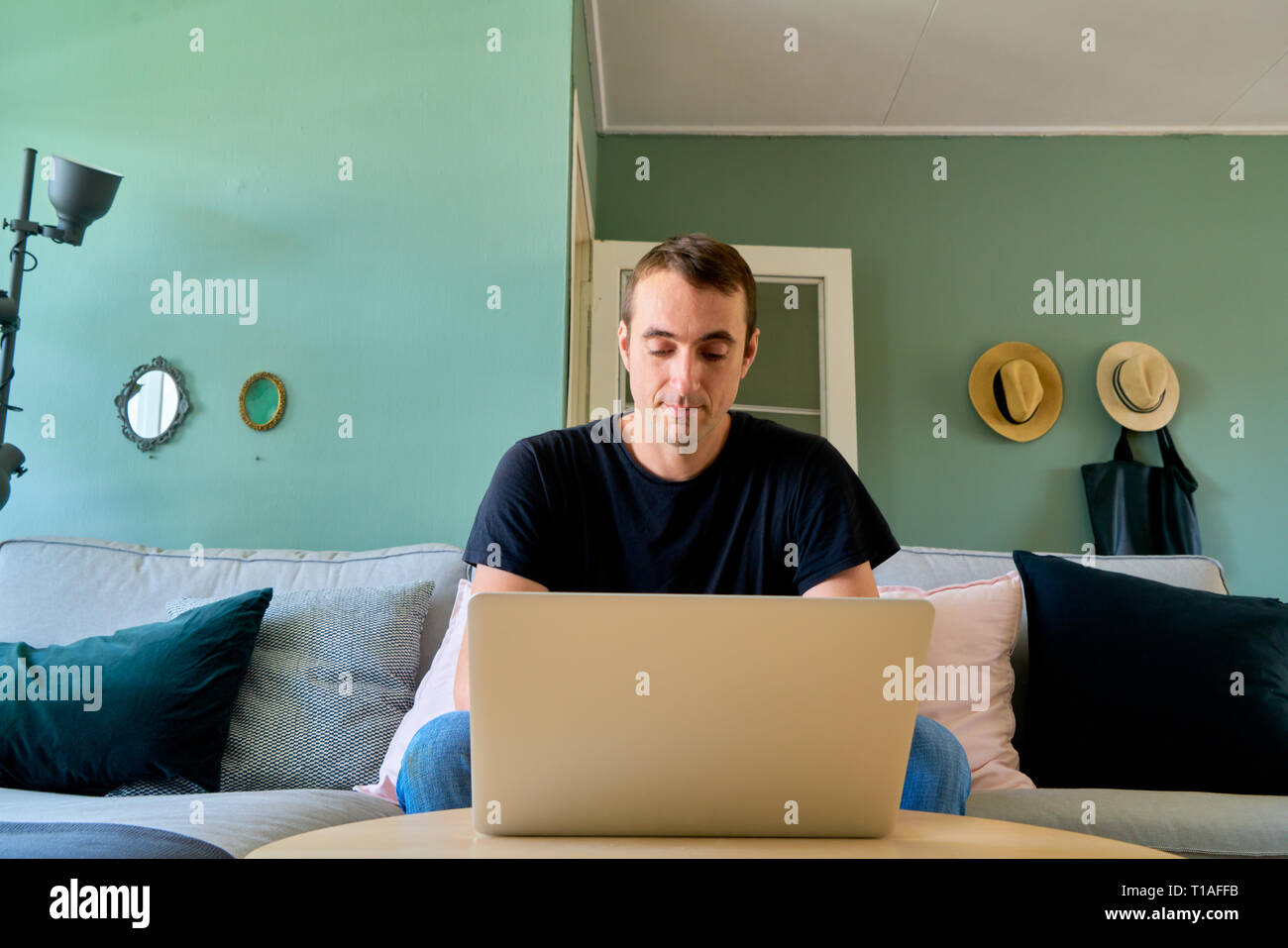 Handsome guy posing - serious, working and typing using laptop Stock ...