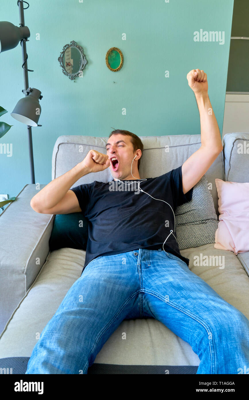 Handsome guy posing - lying down, singing with confident and listening ...
