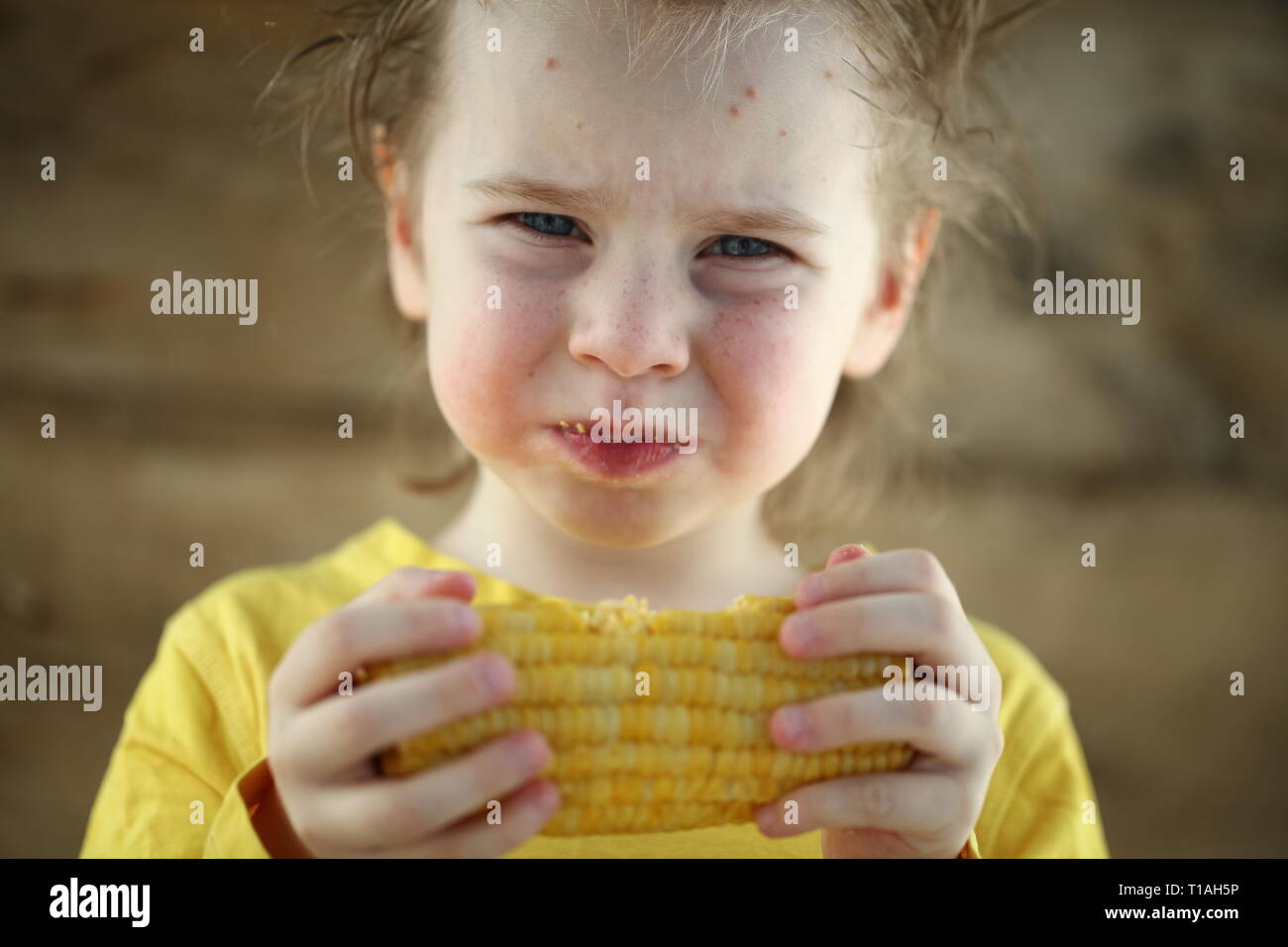 Boy eating sweet corn Stock Photo - Alamy