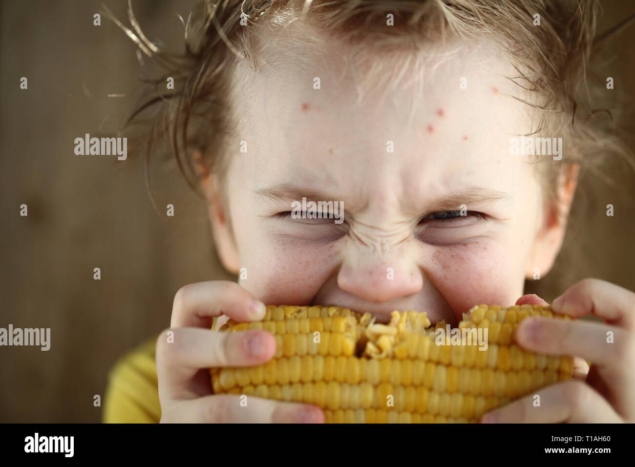 Boy eating sweet corn Stock Photo - Alamy