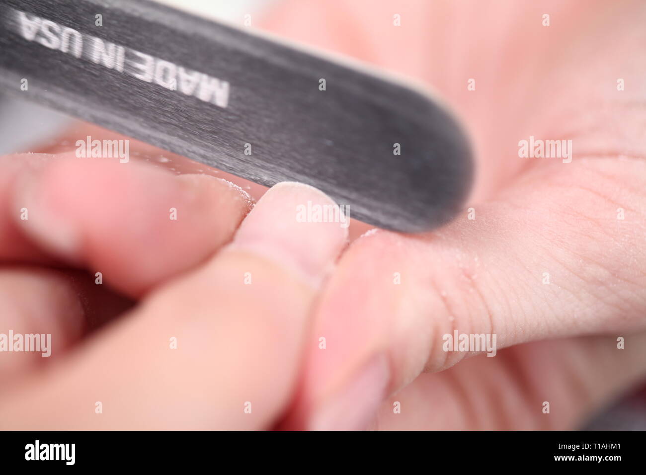 female nail manicure processing Stock Photo - Alamy