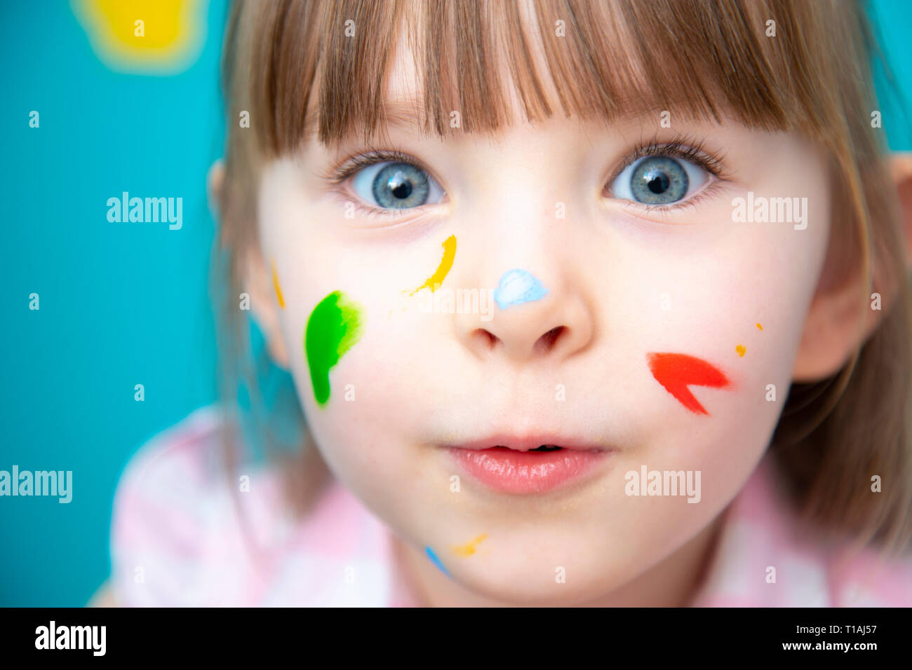 kid with face painted with different colors Stock Photo - Alamy