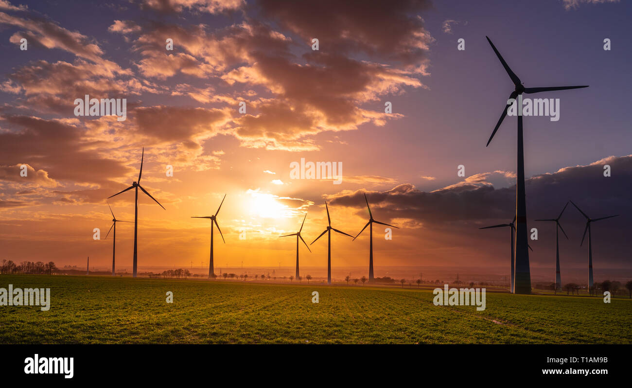 Sunset over wind turbines Stock Photo - Alamy
