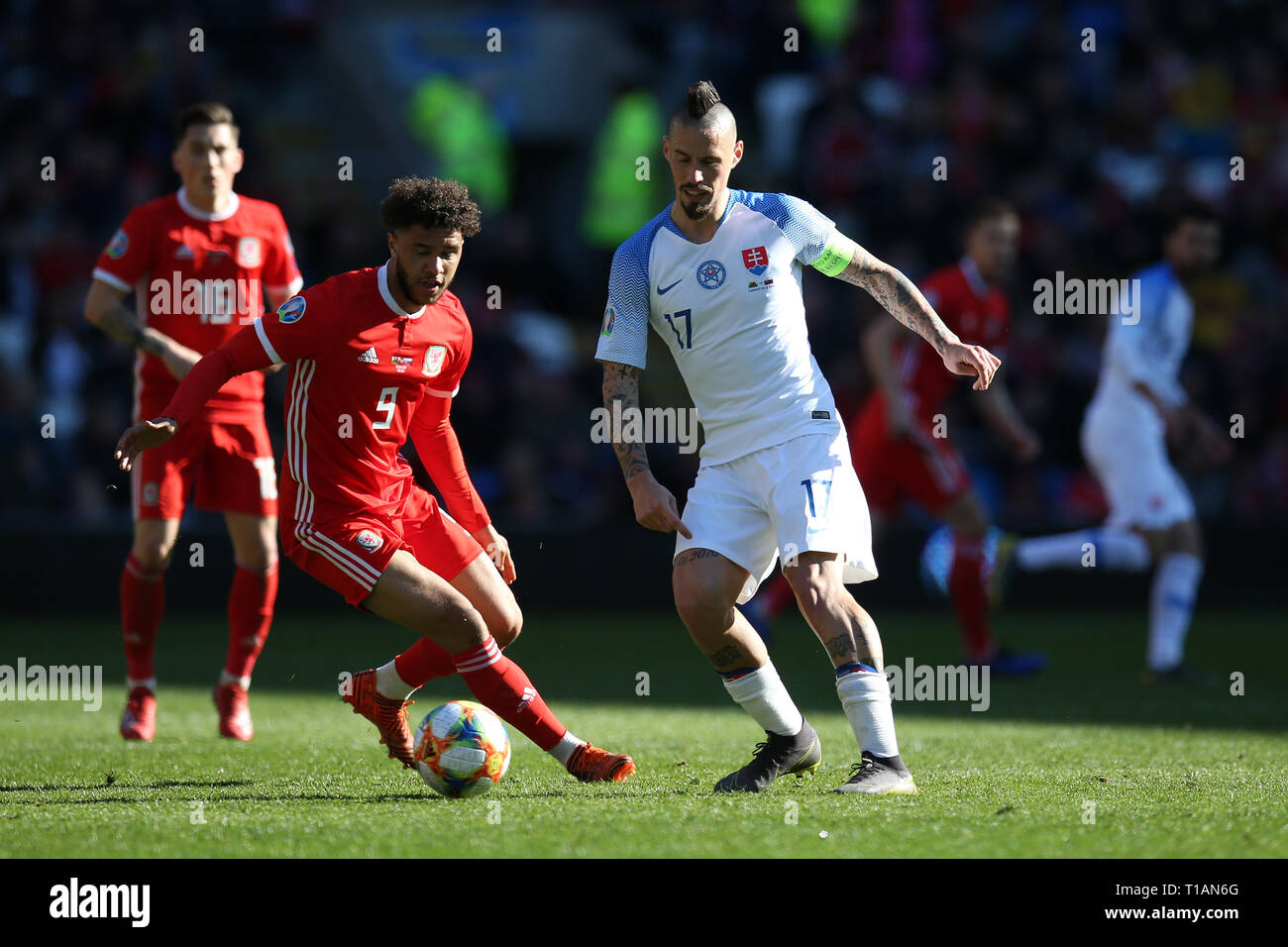 Cardiff, Wales, UK. 24th Mar, 2019. Tyler Roberts of Wales and Marek ...