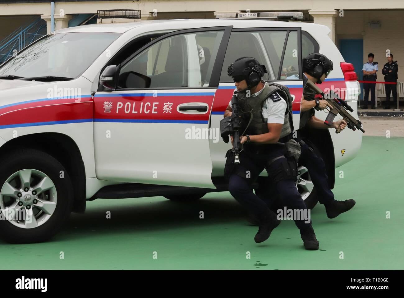 Hong Kong. 25th Mar, 2019. Police officers dash out of a patrol car ...