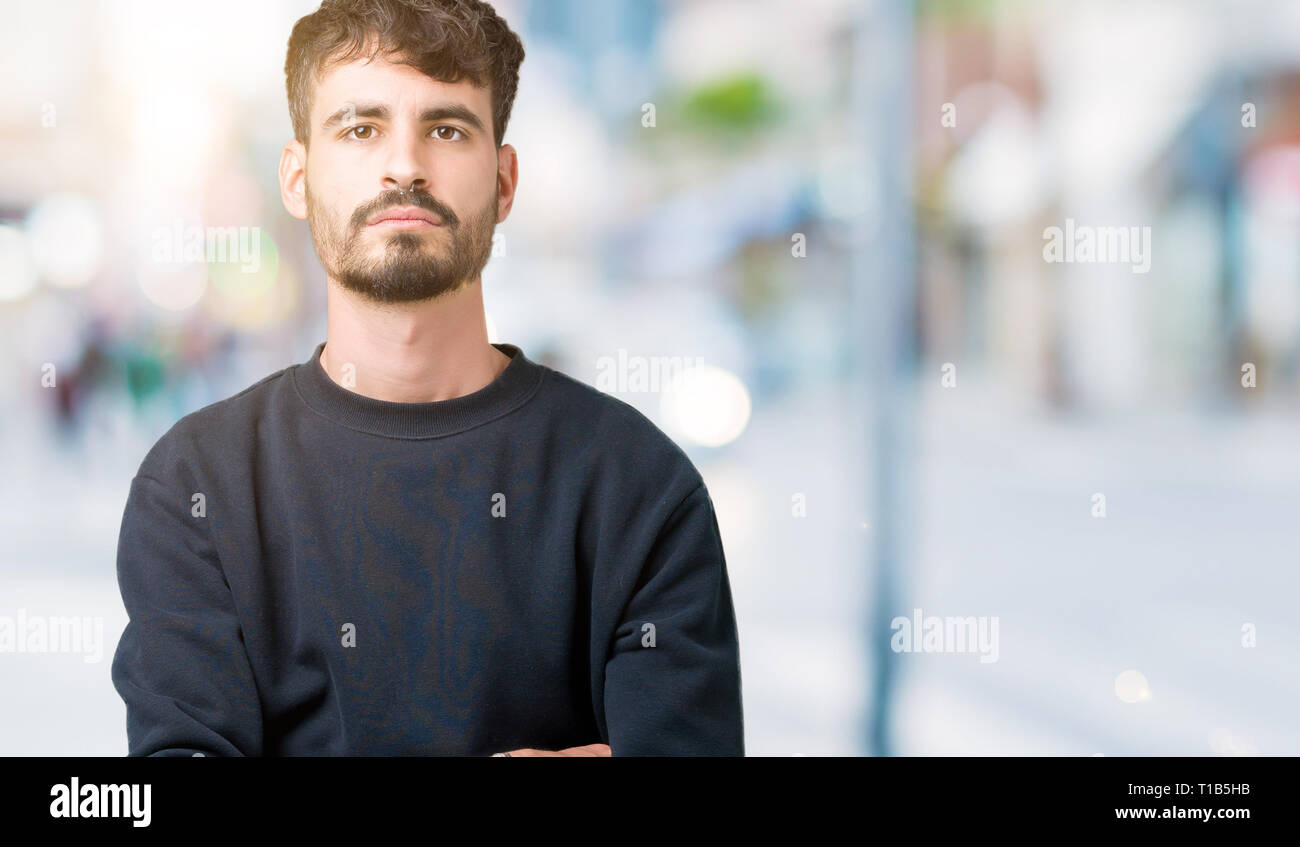 Young handsome man over isolated background Relaxed with serious ...
