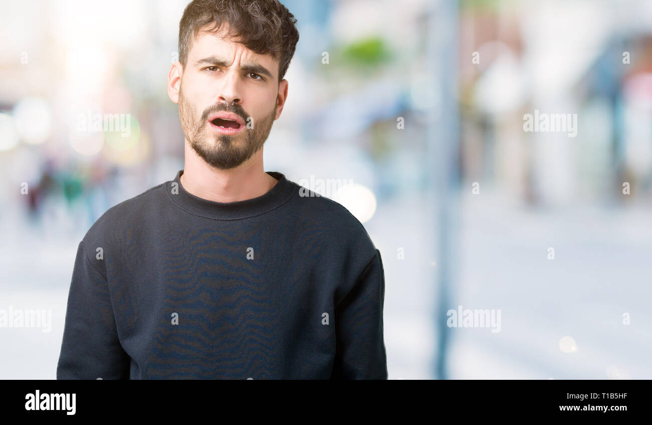 Young handsome man over isolated background In shock face, looking ...