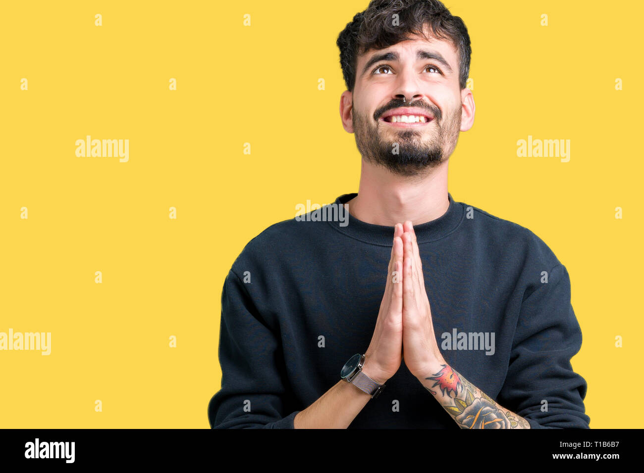 Young handsome man over isolated background begging and praying with ...