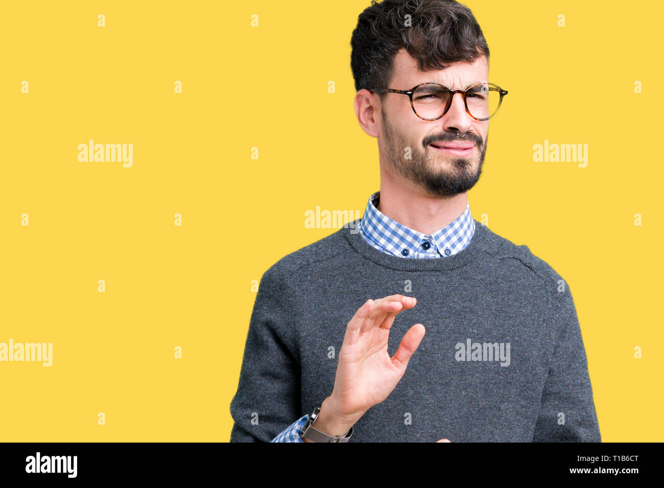 Young handsome smart man wearing glasses over isolated background ...