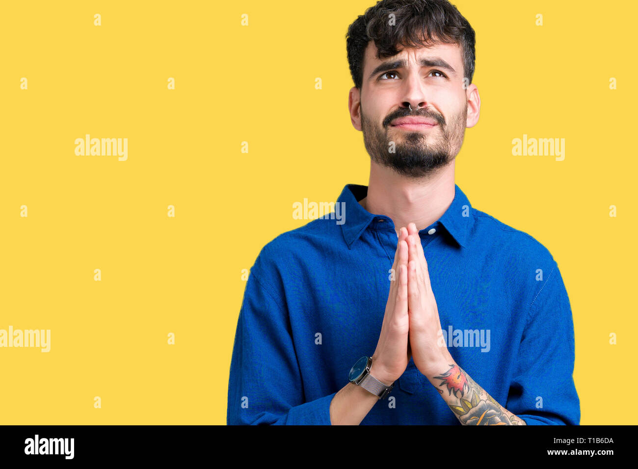 Young handsome man over isolated background begging and praying with ...