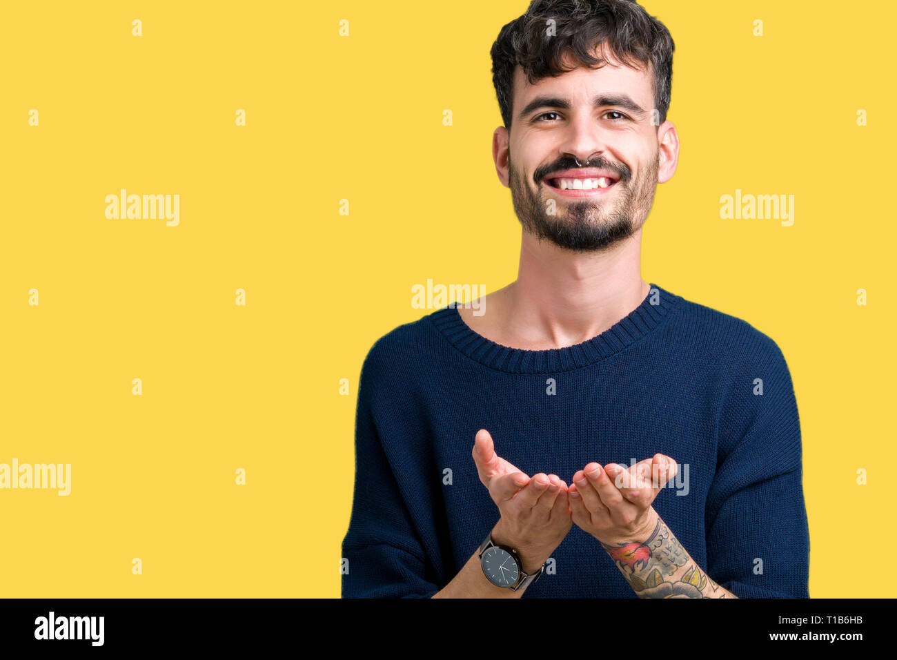 Young handsome man over isolated background Smiling with hands palms ...
