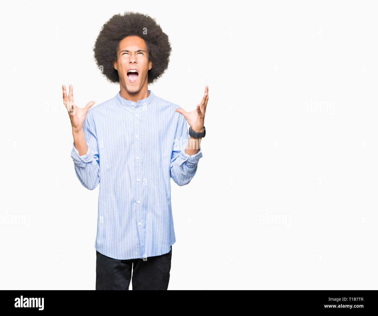 Young african american man with afro hair crazy and mad shouting and ...