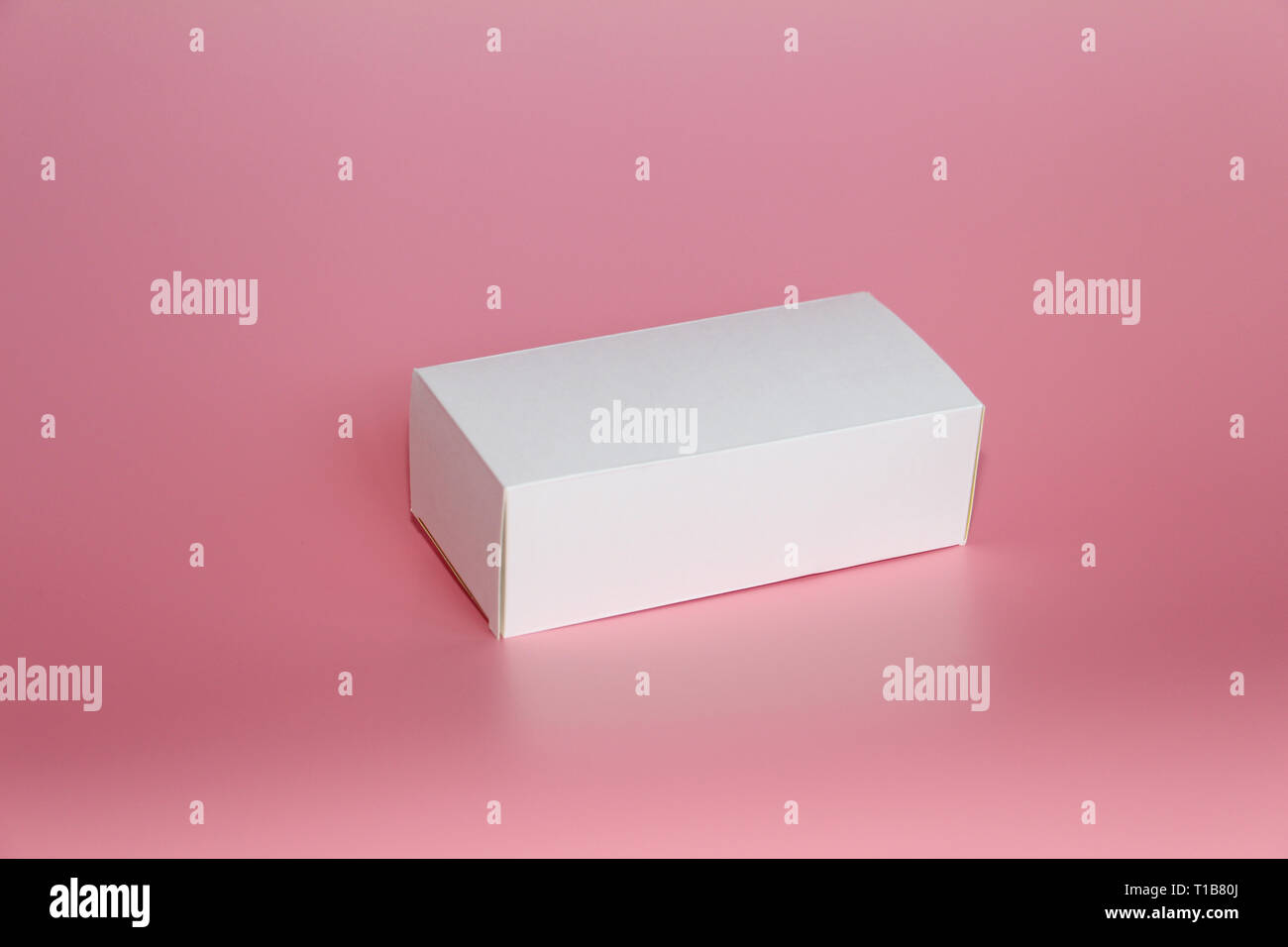 White box lies on a pink background. Horizontal white box. Pink ...