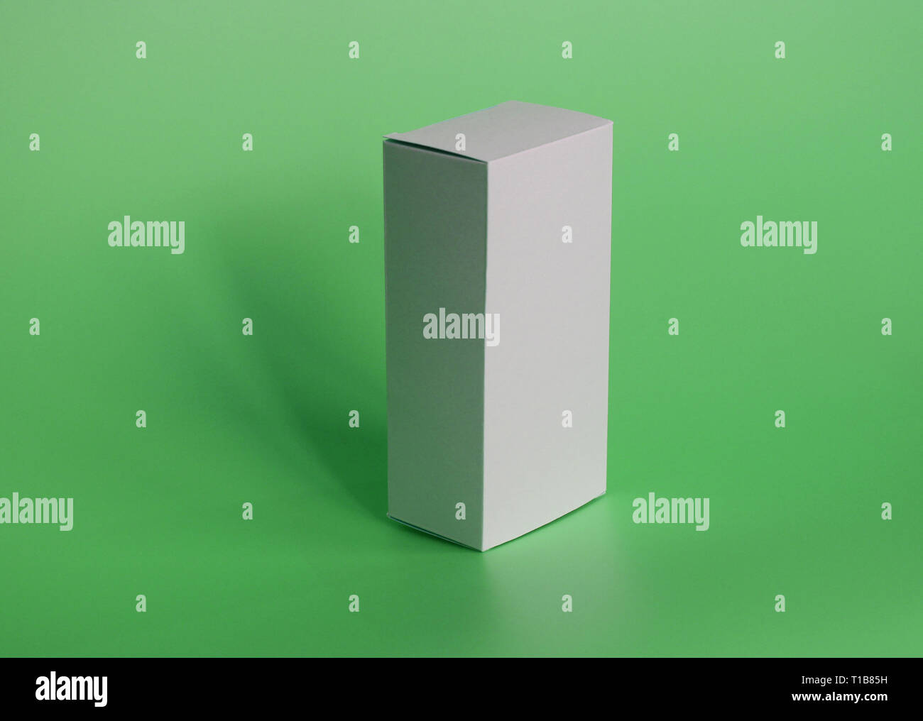 One white box on a green background. The box stands vertically. Green ...