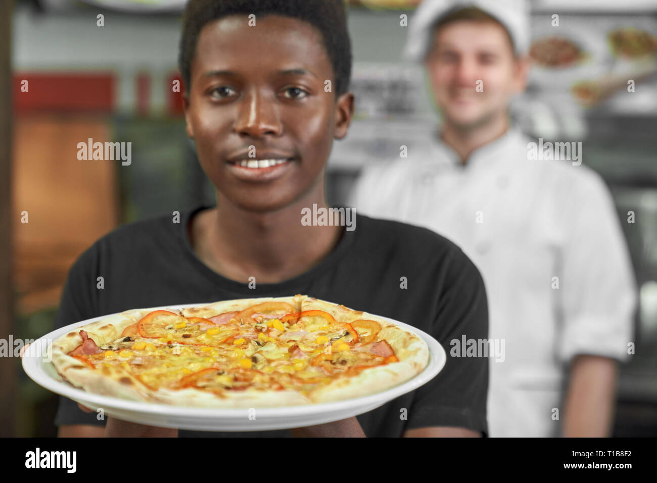 Chef man holding two pizza hi-res stock photography and images - Alamy