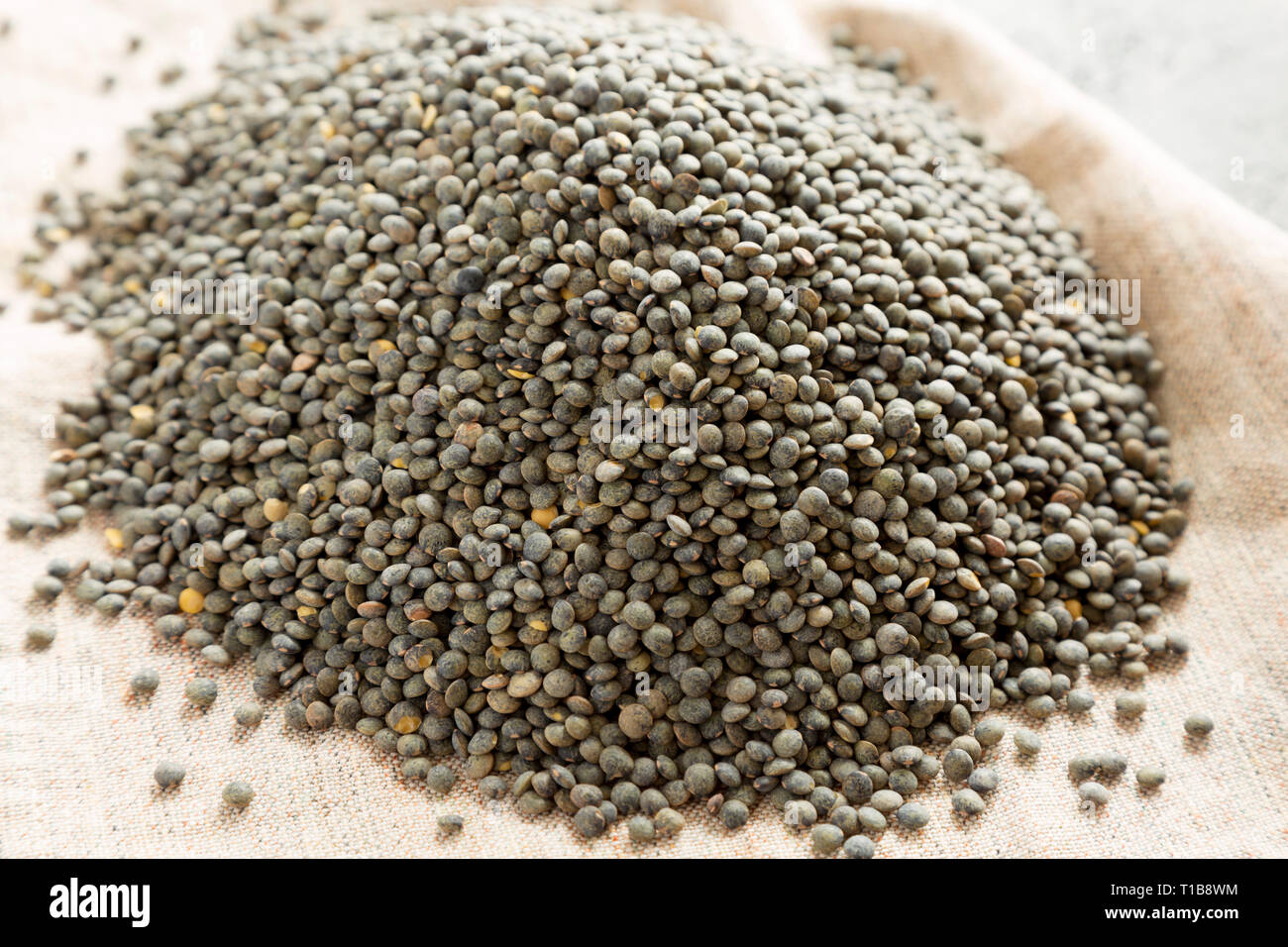 Dry green french lentils on cloth, side view. Close-up Stock Photo - Alamy