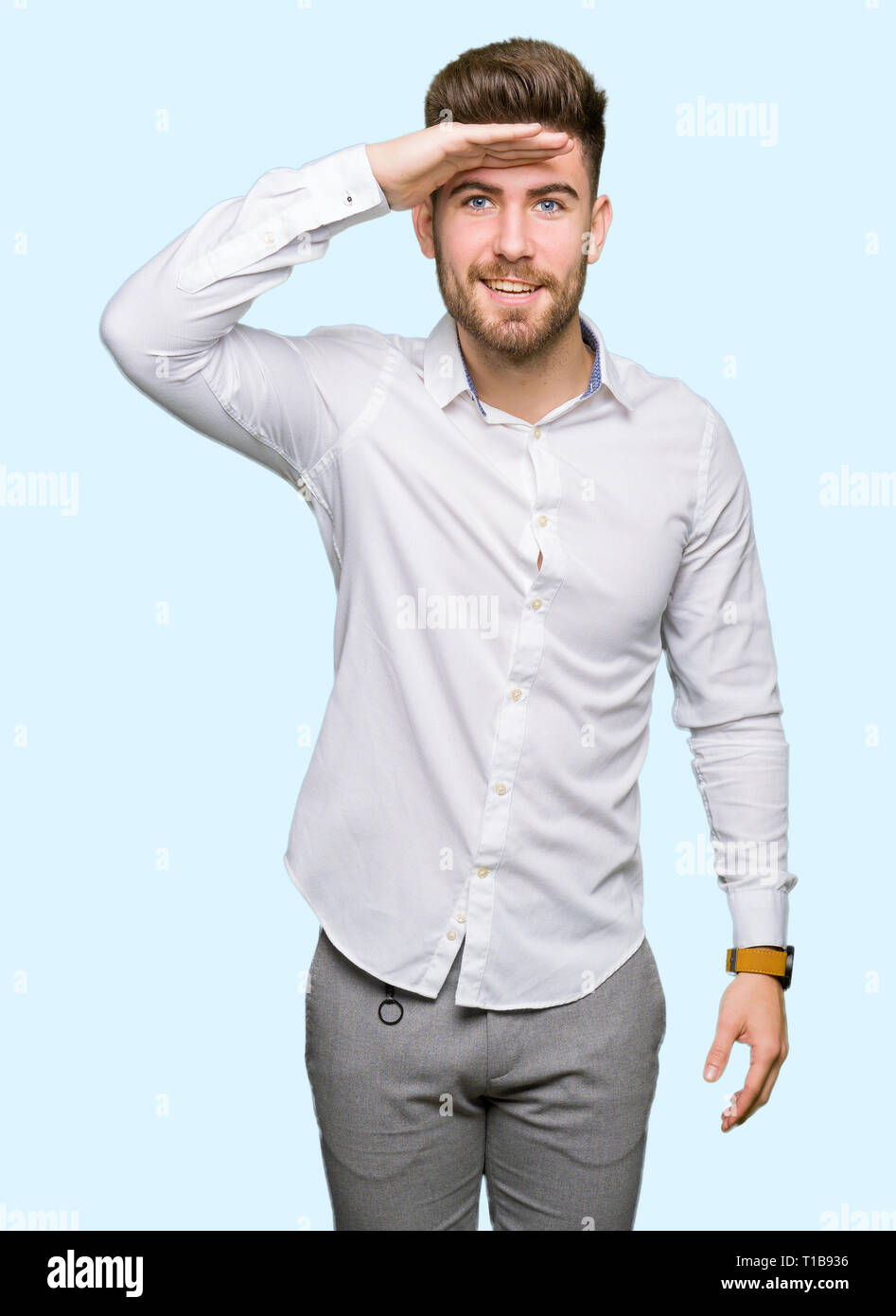 Young handsome business man very happy and smiling looking far away ...