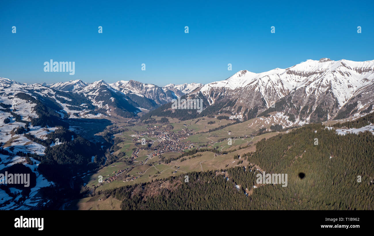 Stunning Aerial views over the a Swiss Alpine town and valley basin ...