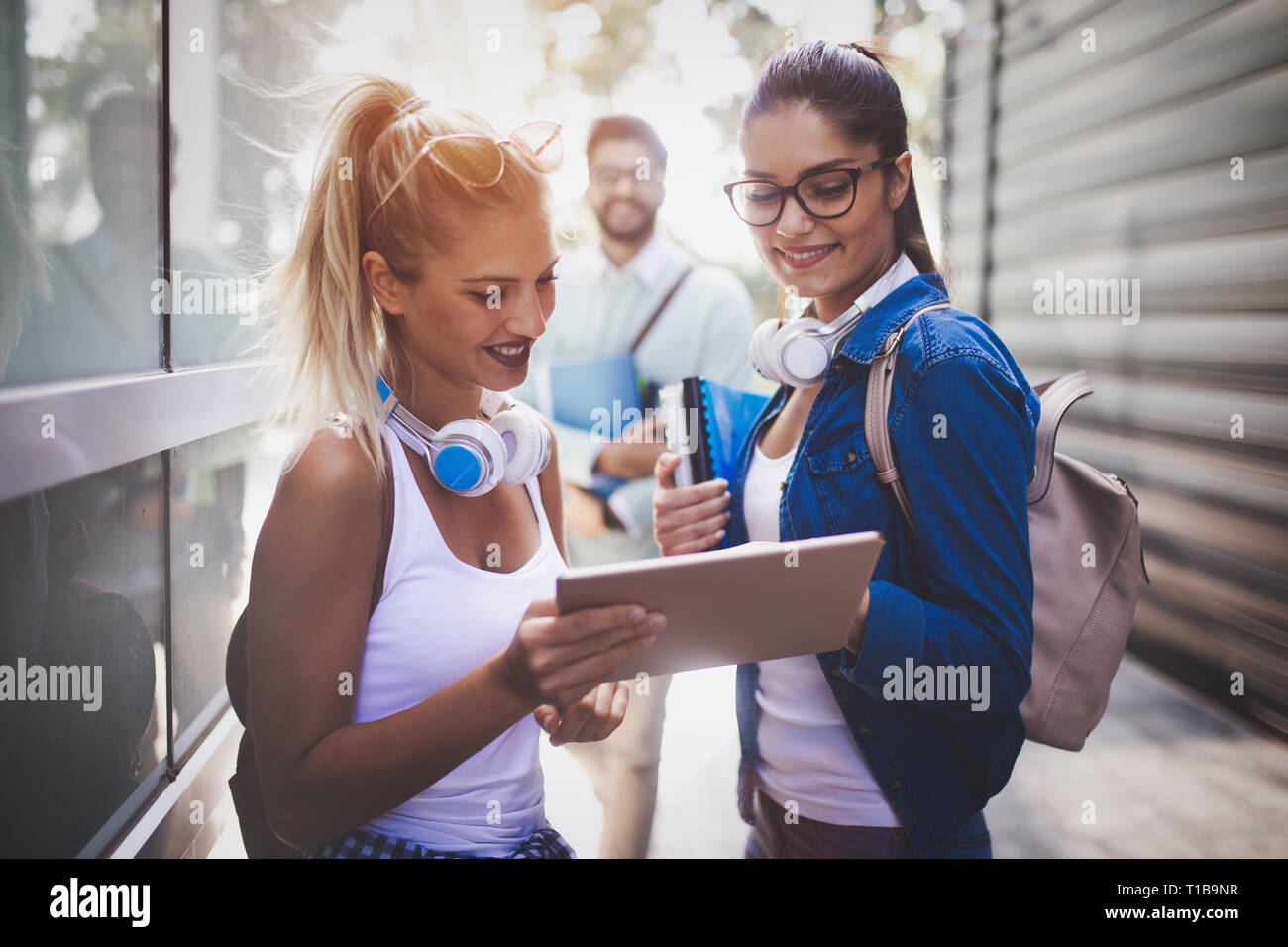 Happy young university students friends studying with books at ...