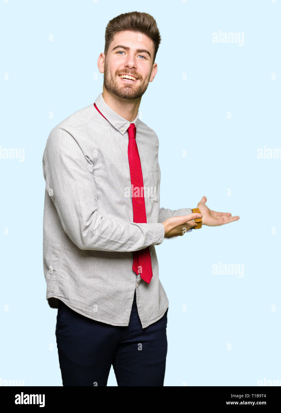 Young handsome business man Inviting to enter smiling natural with open ...