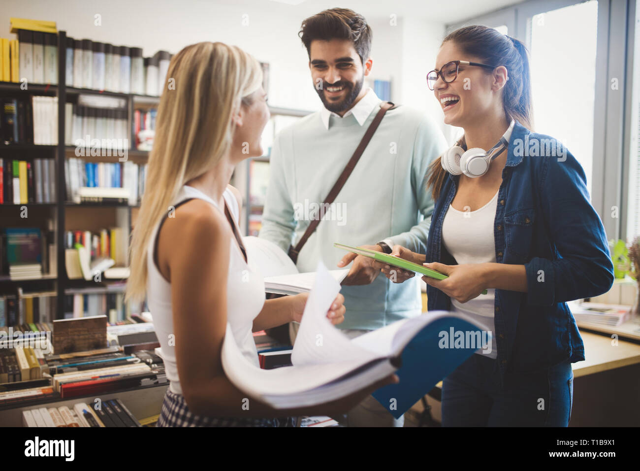 Happy young university students studying together. Group of multiracial ...