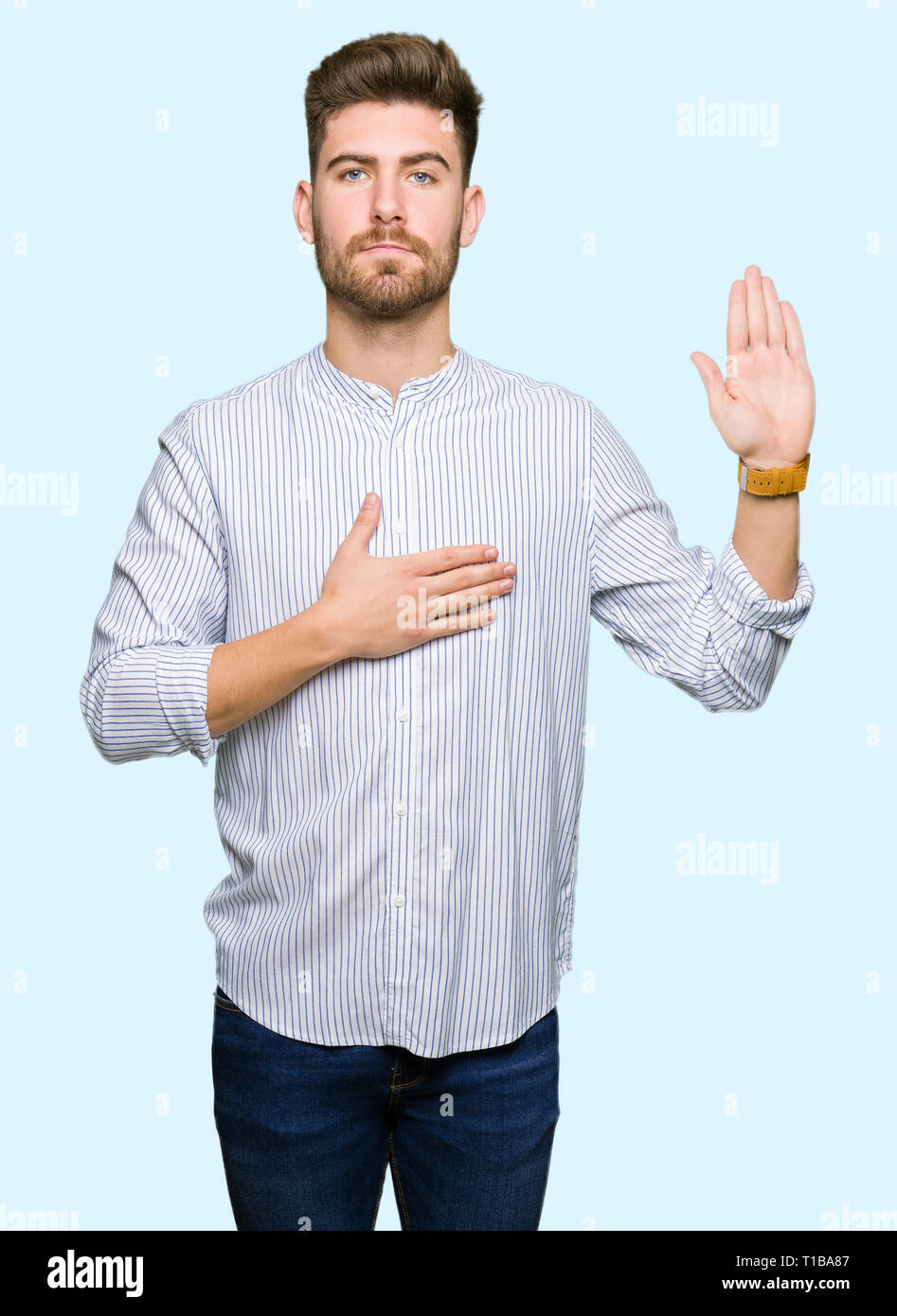Young handsome man Swearing with hand on chest and open palm, making a ...