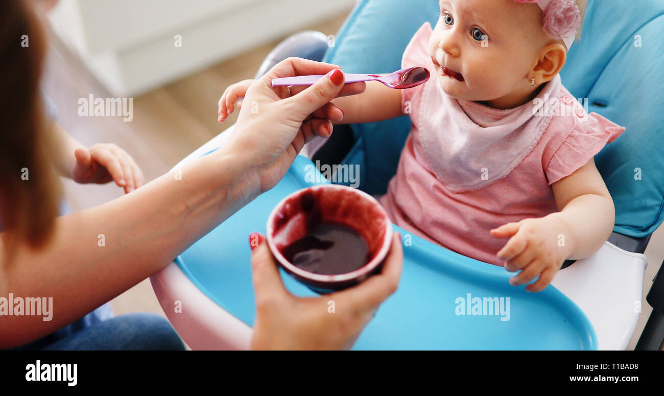 Woman feeding mother at table hi-res stock photography and images - Alamy