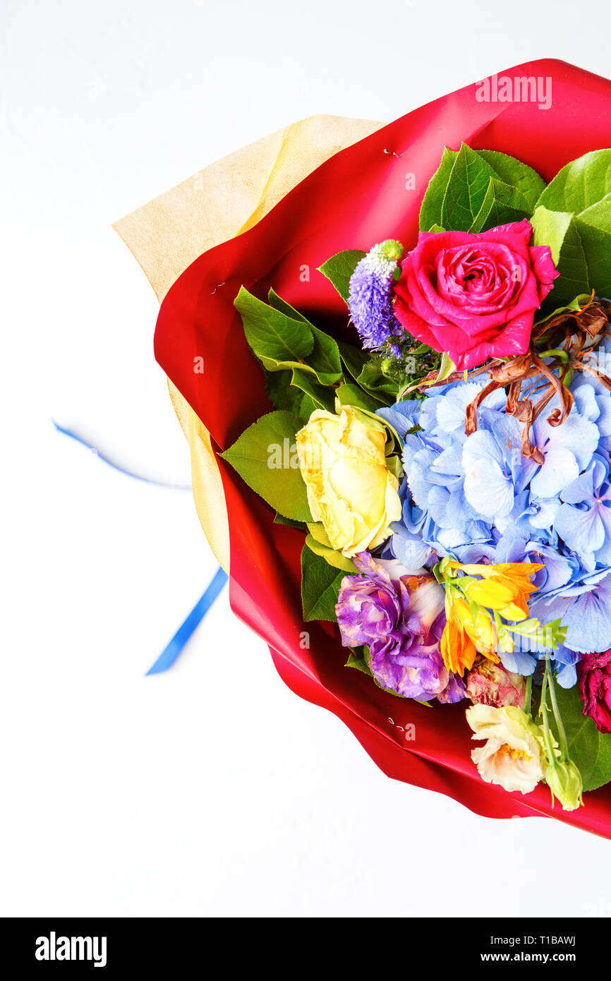 Photo from above bouquet of multi-colored roses with card on empty ...