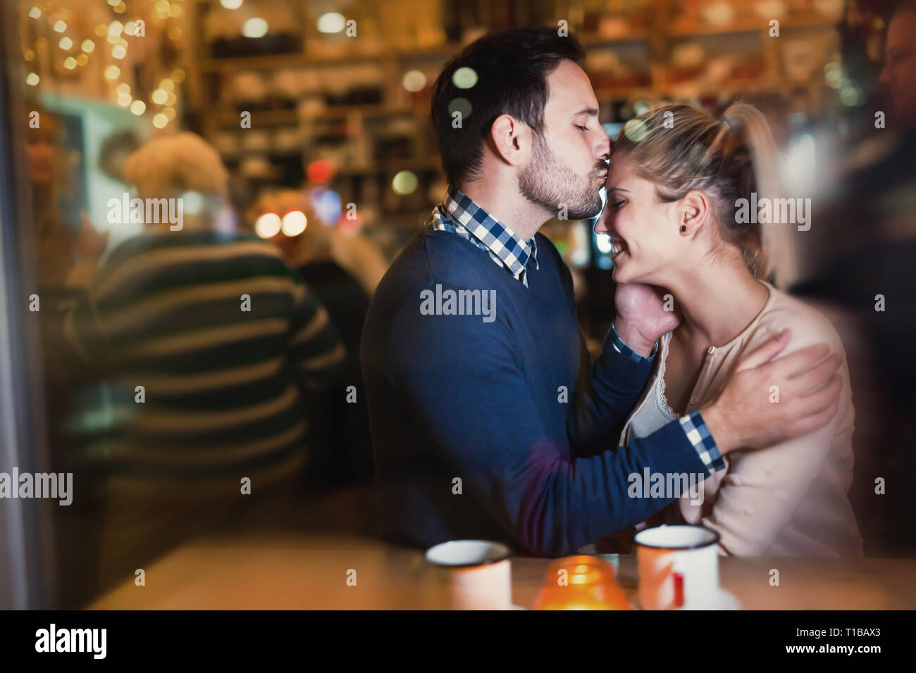 Young attractive couple on date in bar Stock Photo - Alamy