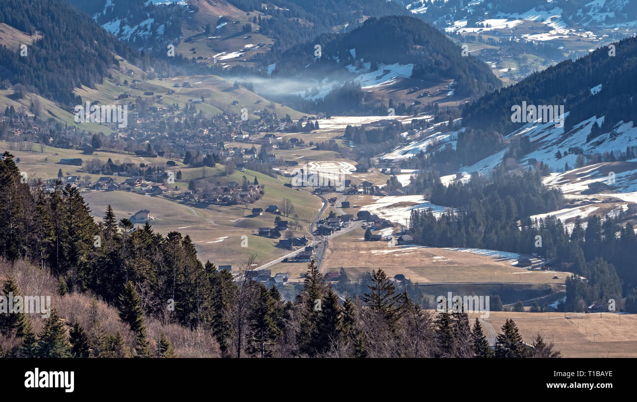 Stunning Aerial views over the a Swiss Alpine town and valley basin ...
