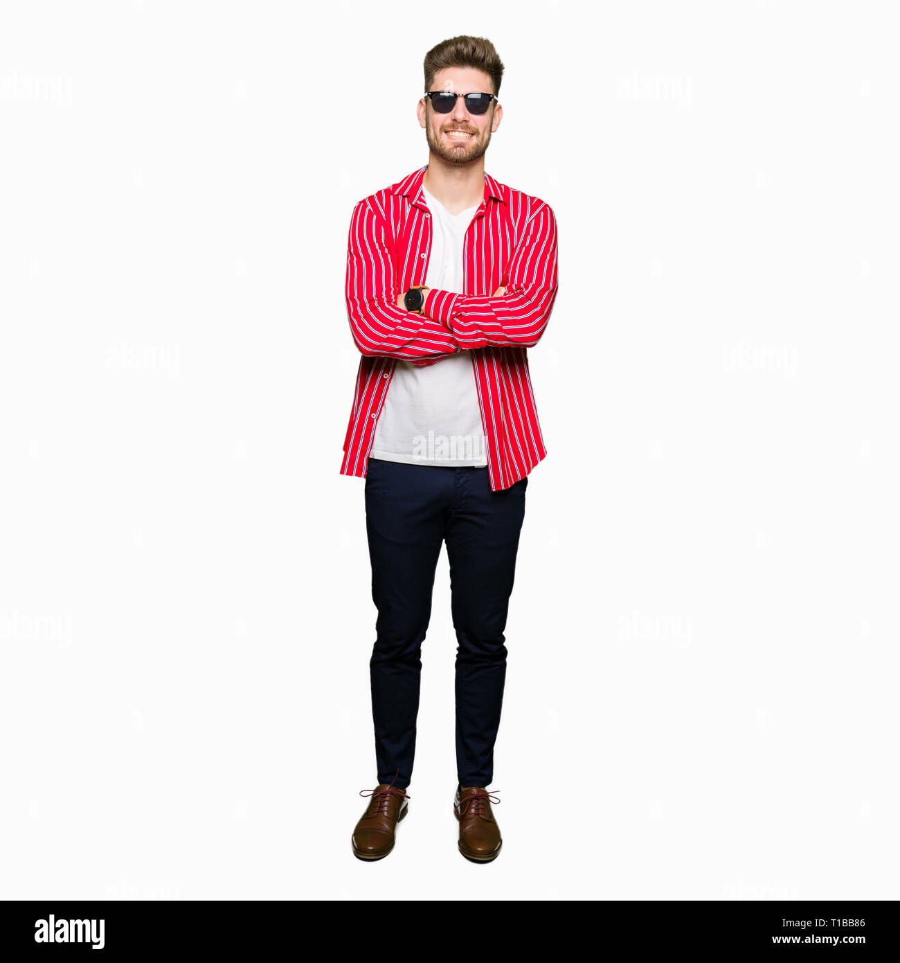 Young handsome man wearing sunglasses happy face smiling with crossed ...