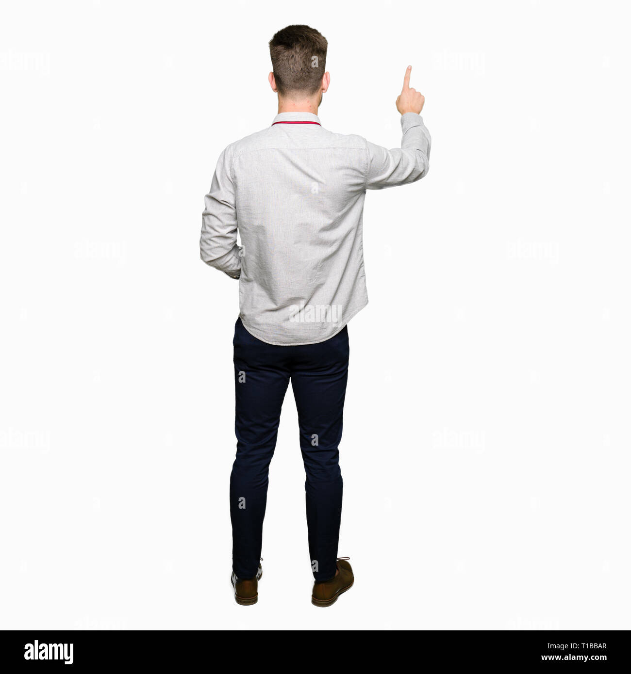 Young handsome business man Posing backwards pointing behind with ...