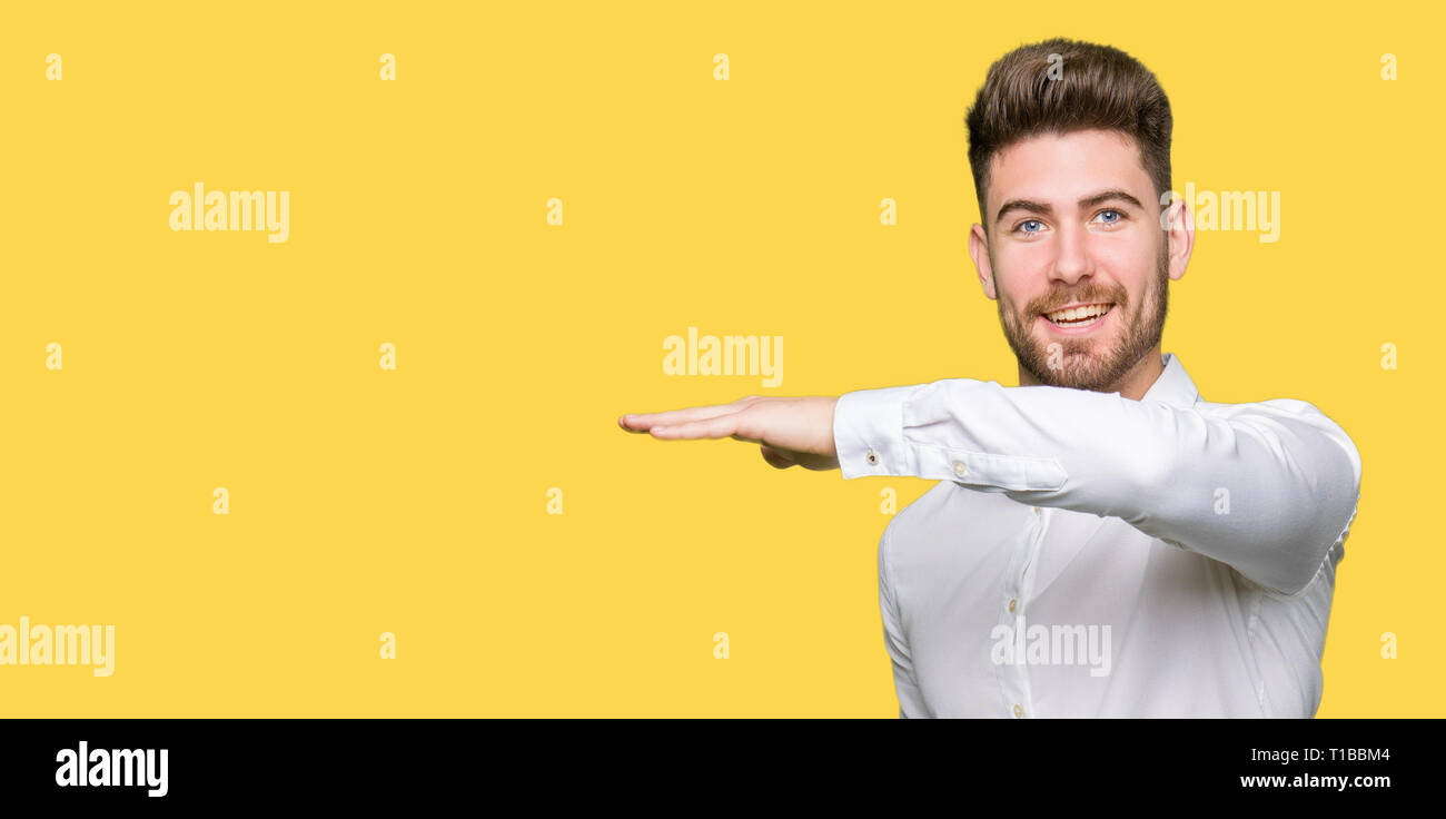 Young handsome business man gesturing with hands showing big and large ...