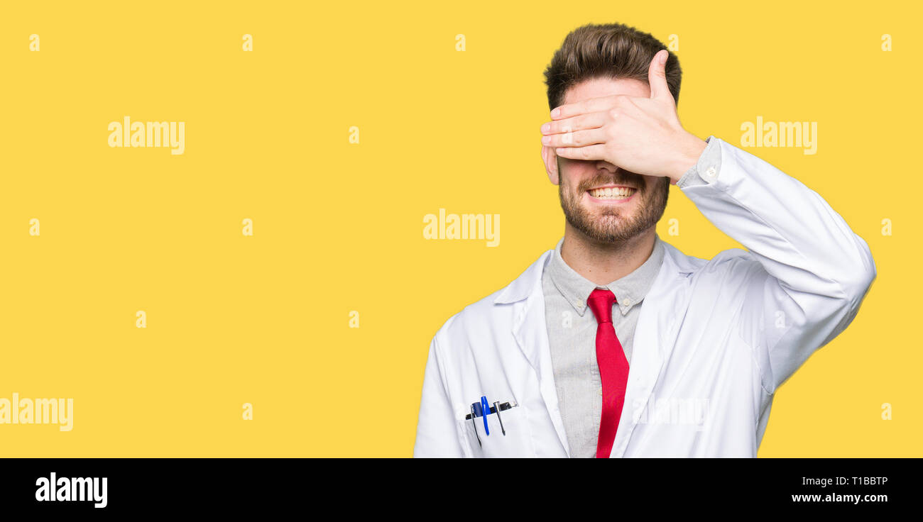 Young handsome scientist man wearing glasses smiling and laughing with ...