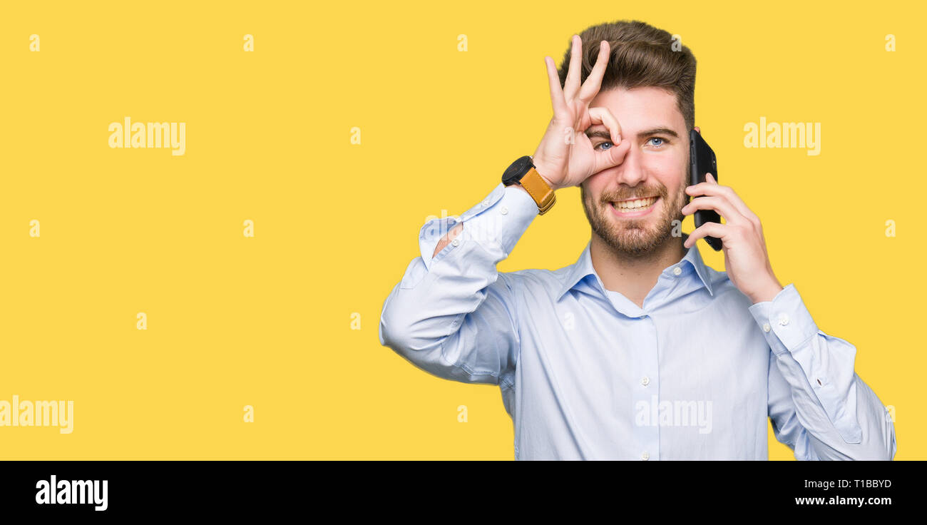 Young handsome man business talking on smartphone with happy face ...