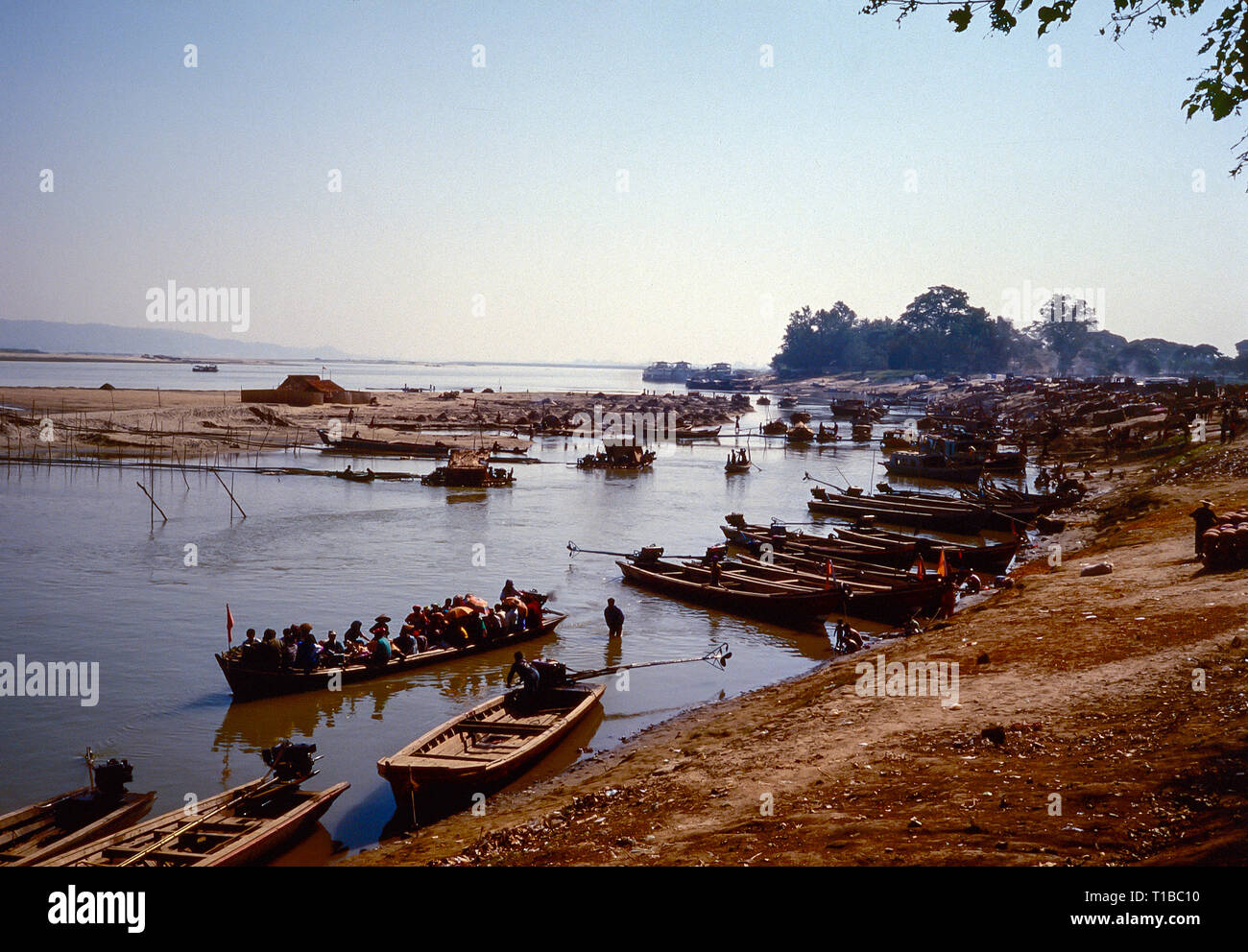 Myanmar. People at work collecting sand for construction work on the ...