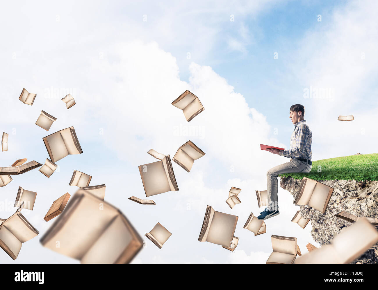 Man reading book and many of them flying in air Stock Photo - Alamy