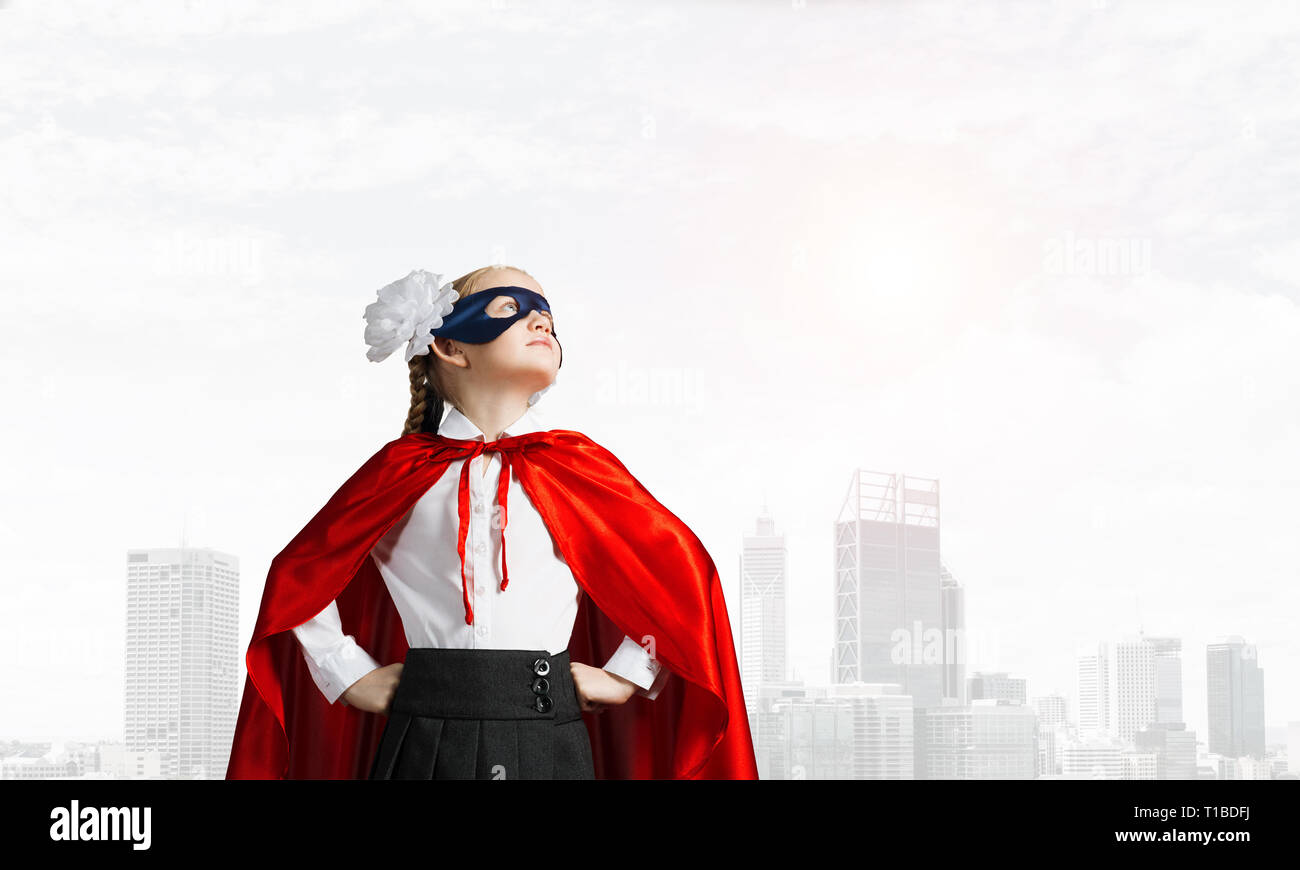 Girl power concept with cute kid guardian against cityscape background ...