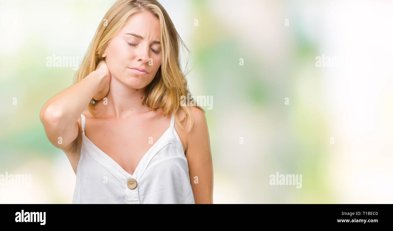 Beautiful young woman over isolated background Suffering of neck ache ...