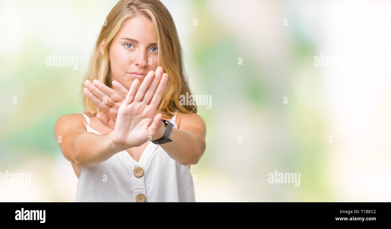 Beautiful young woman over isolated background Rejection expression ...