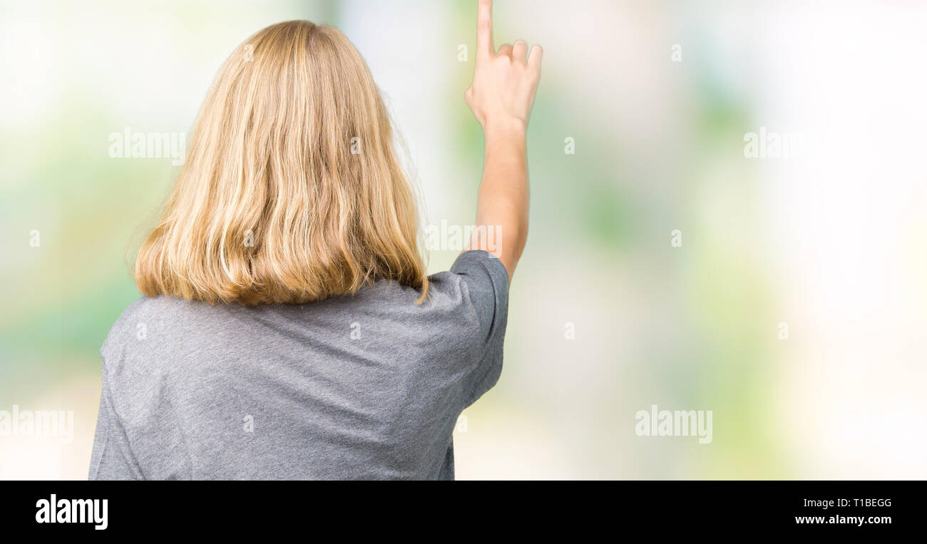 Beautiful young woman wearing oversize casual t-shirt over isolated ...