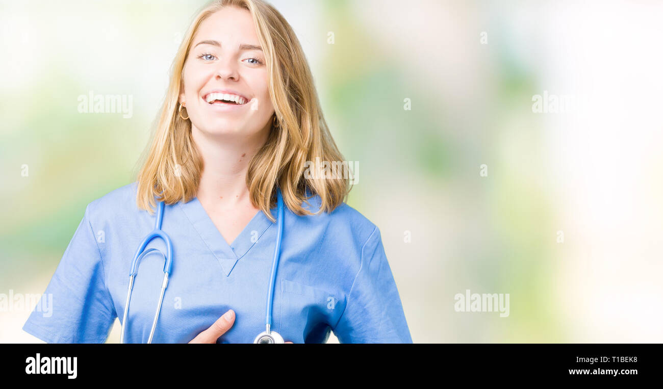 Beautiful young doctor woman wearing medical uniform over isolated ...