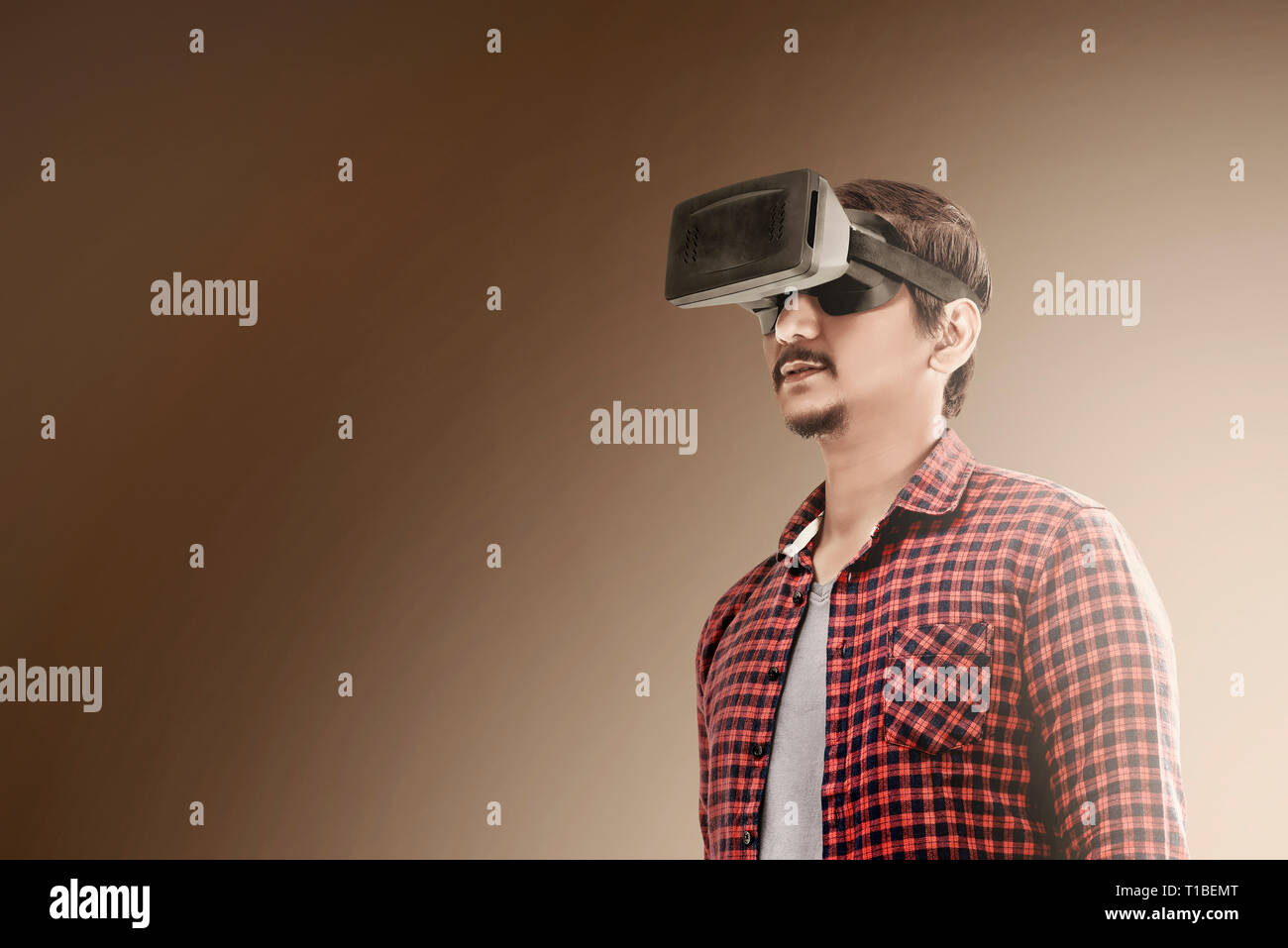 Asian man using virtual reality device. Augmented reality technology ...