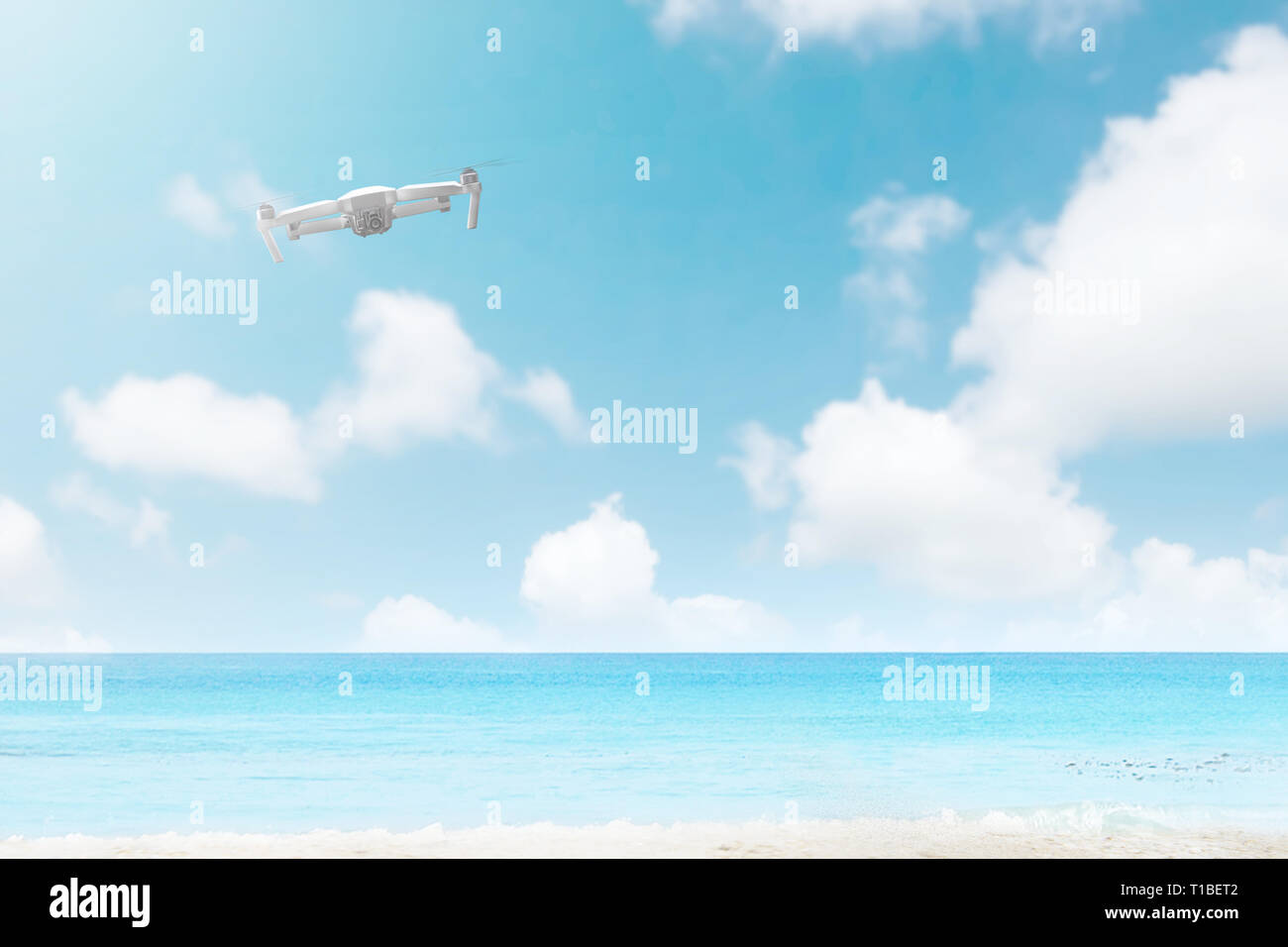 White drone with camera flying over the beach with blue ocean and blue ...
