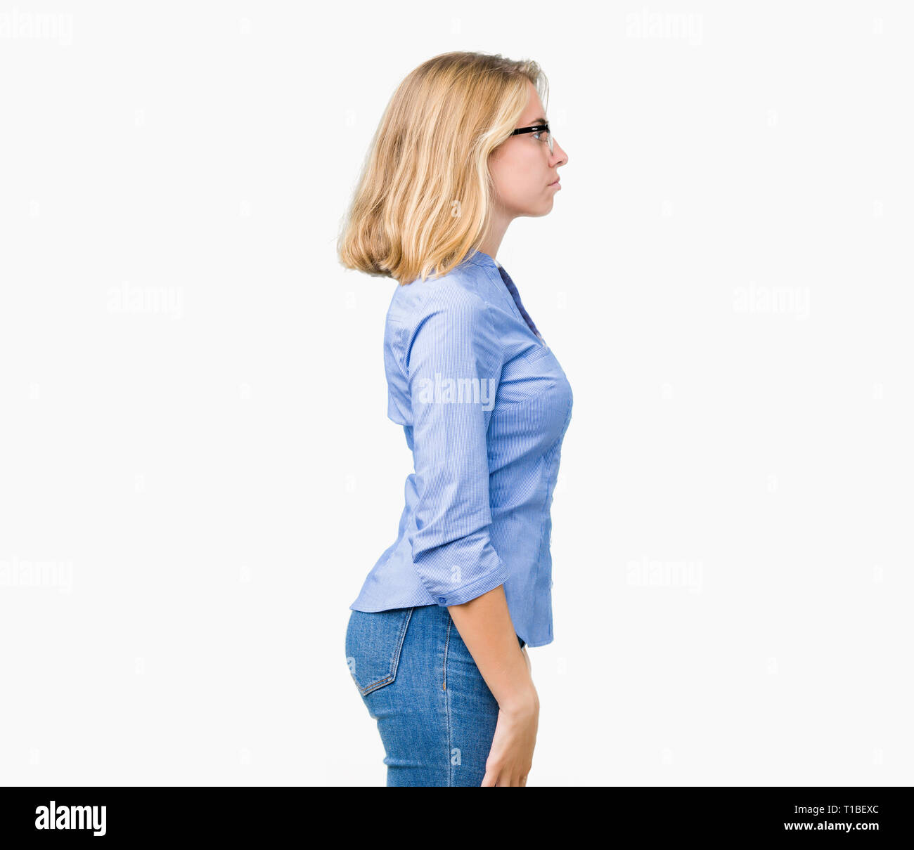 Beautiful young business woman over isolated background looking to side ...