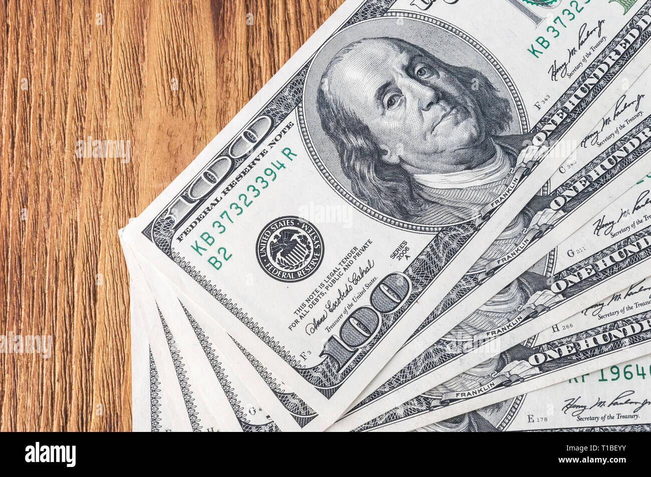 Dollar banknotes in fan at wooden background Stock Photo - Alamy