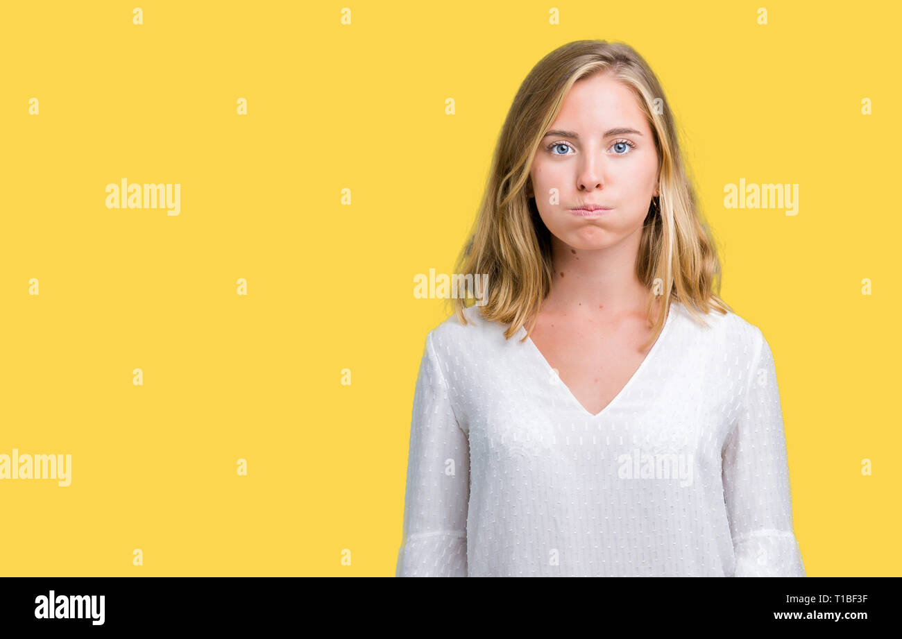 Beautiful young elegant woman over isolated background puffing cheeks ...