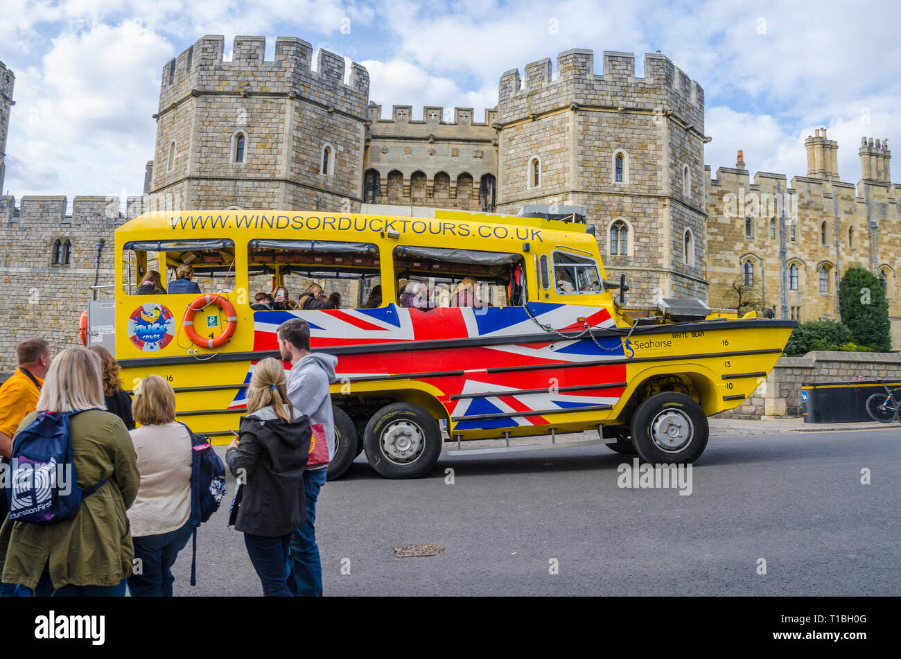 A Windsor Duck Tours amphibious vehicle drives past Windsor Castle ...